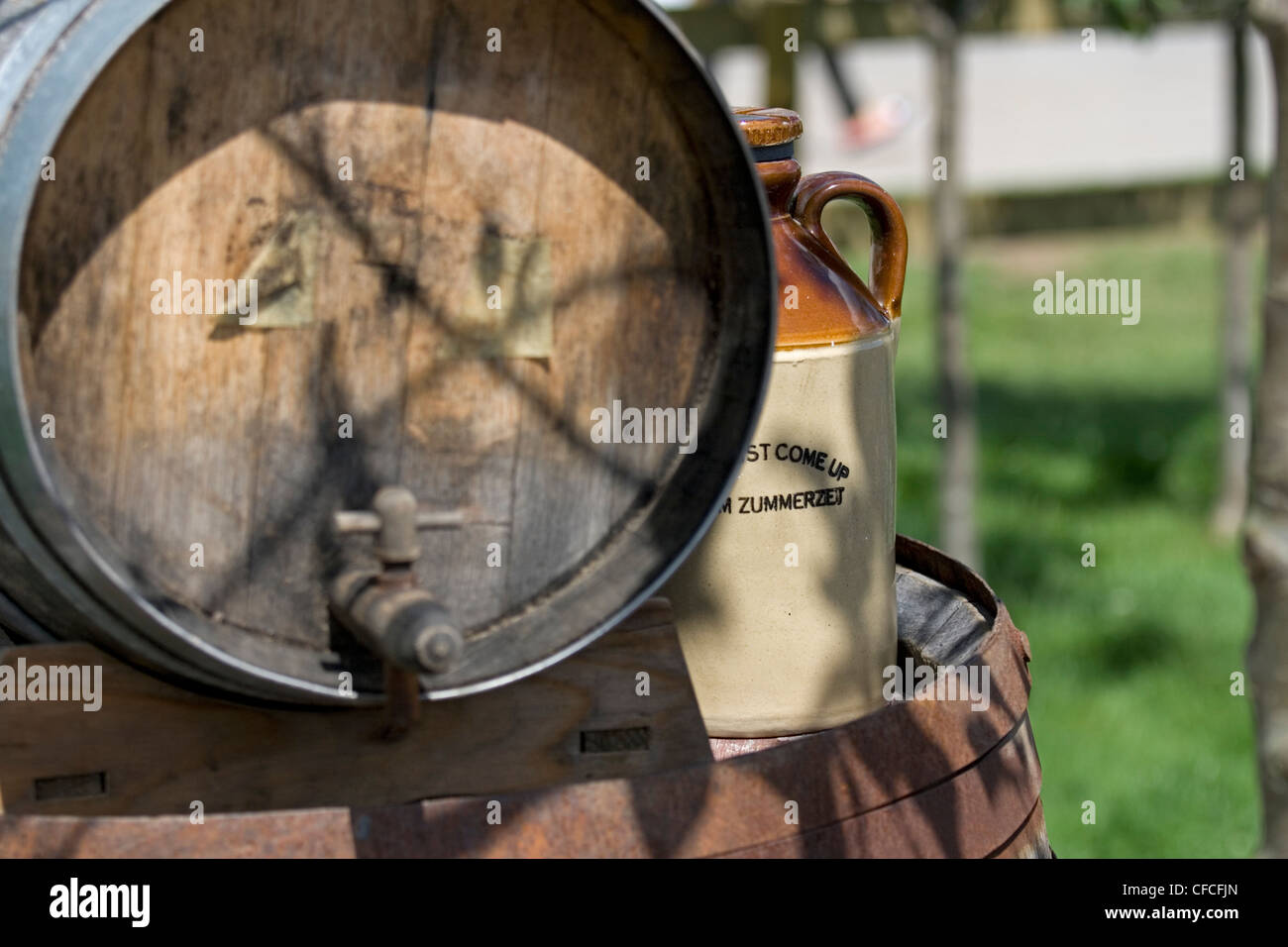 Cider flagon next to barrel Stock Photo - Alamy