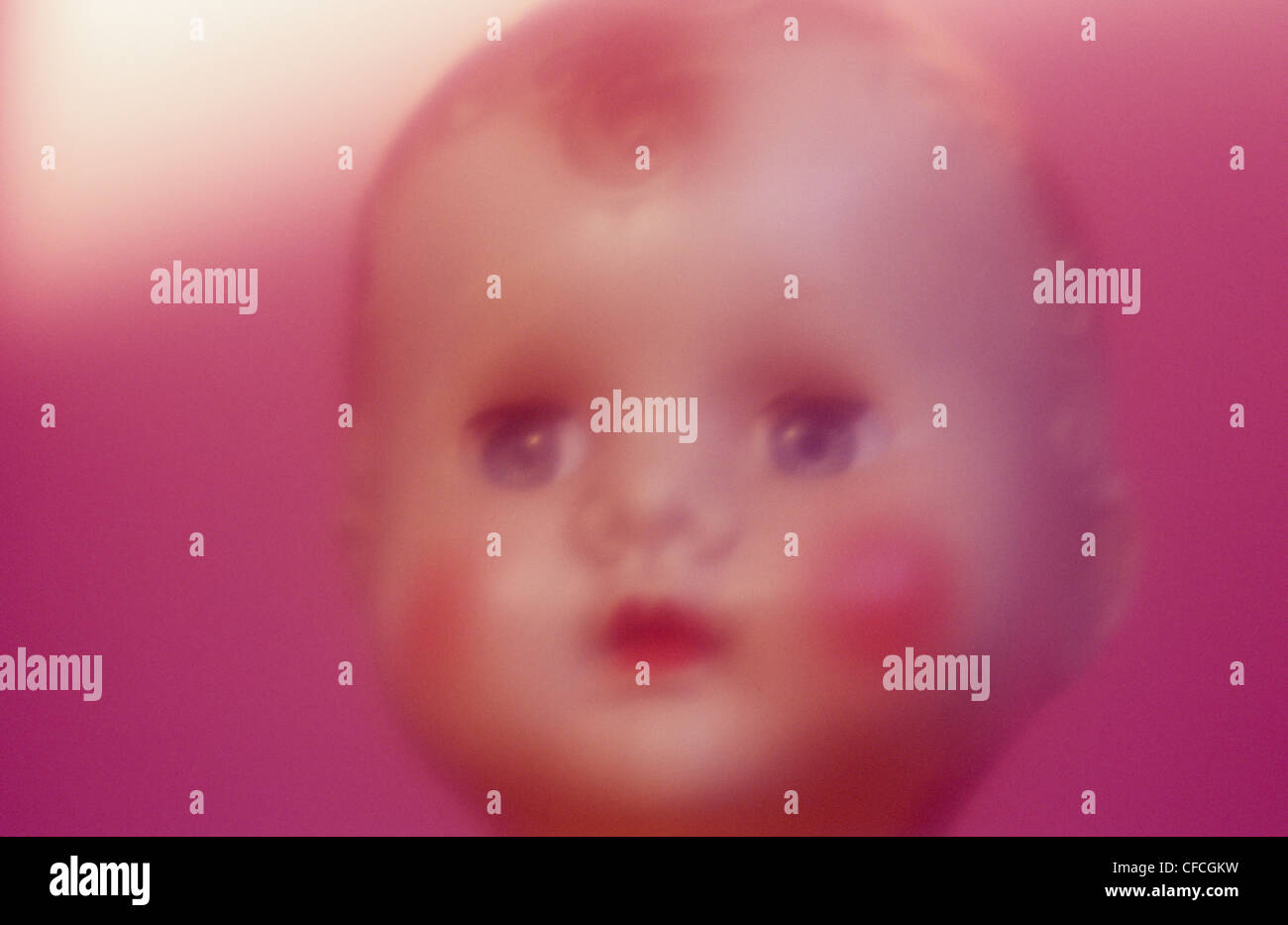 Atmospheric close up of face of traditional baby doll with big staring ...