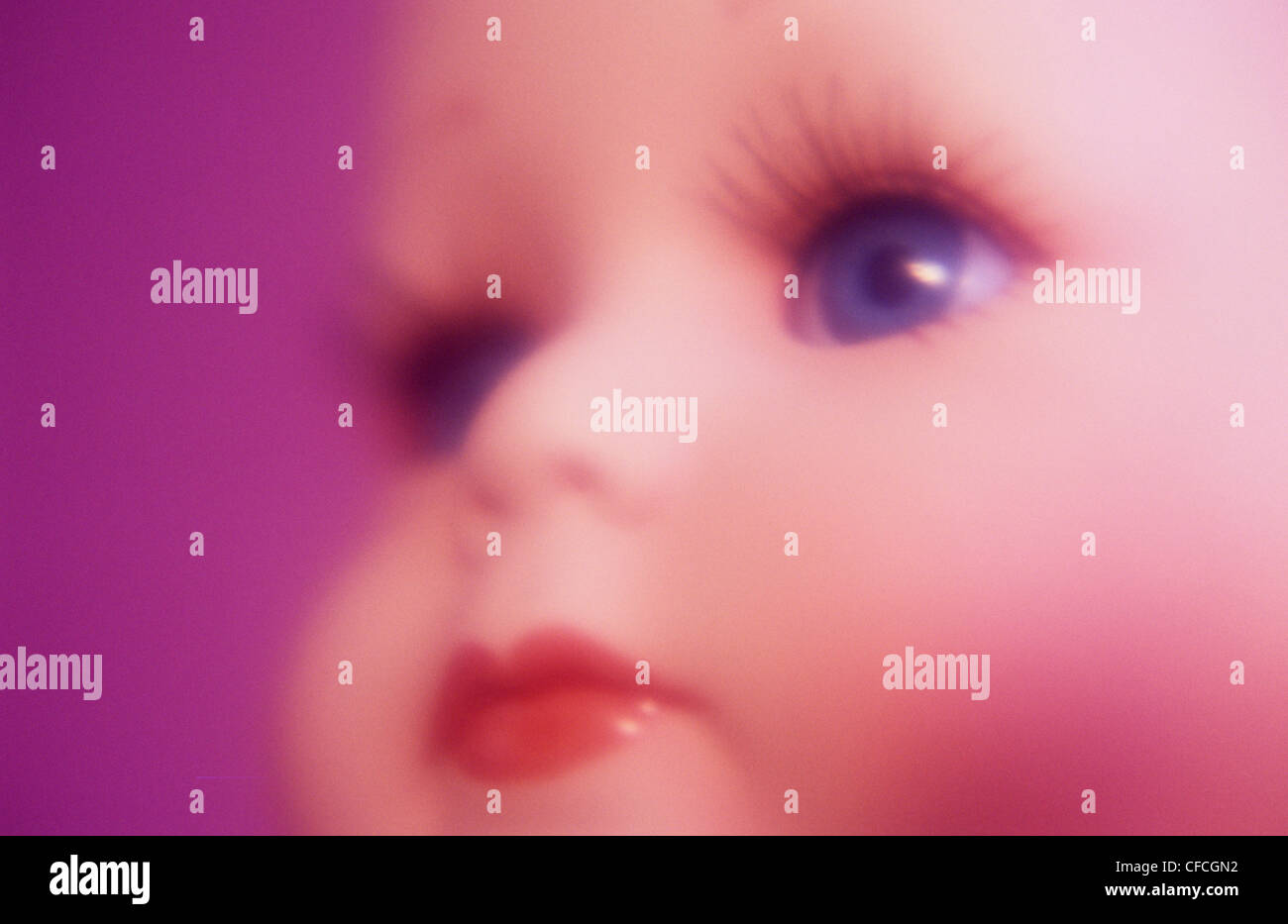 Atmospheric close up of face of traditional baby doll with big staring ...