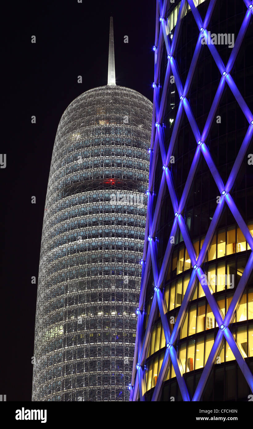 Burj Qatar and the blue illuminated QIPCO Tower in Doha, Qatar Stock ...