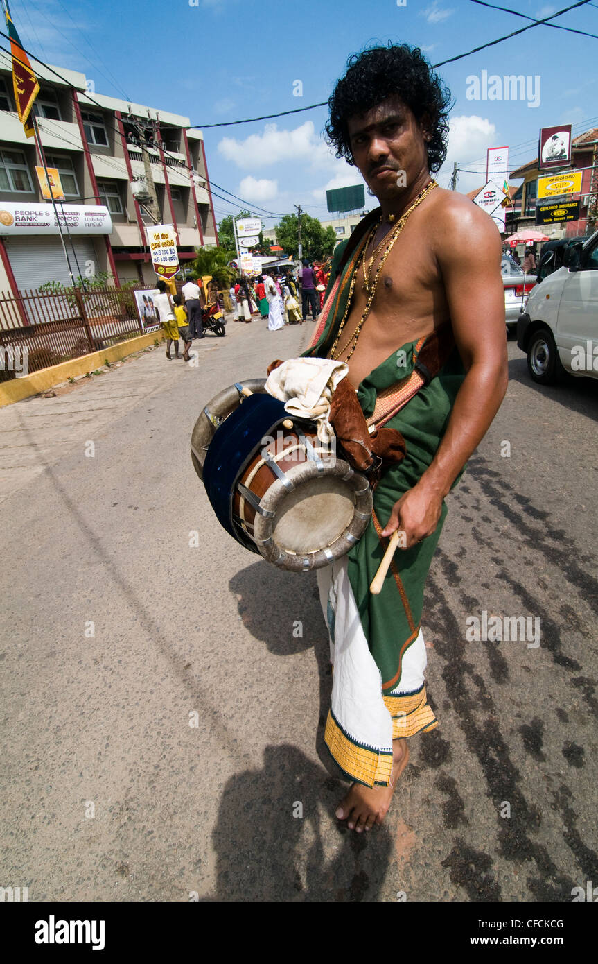 A Sinhalese man playing a traditional drum during a festival in Negombo ...