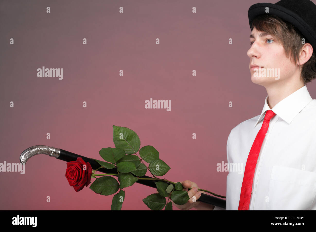 Young men with the red rose on colour background. Love and reflection ...