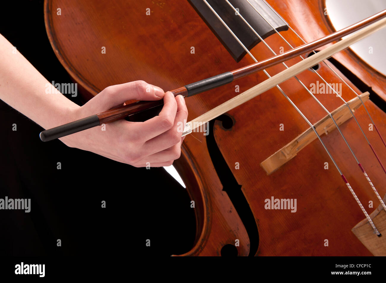 close-up on a female hand with bow playing the bass Stock Photo - Alamy