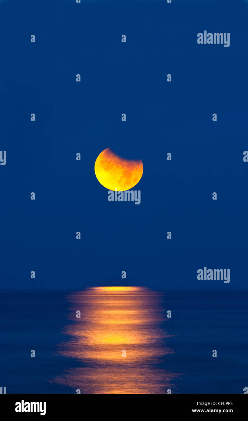 Partial eclipse of the moon, setting over the gulf of mexico on the ...