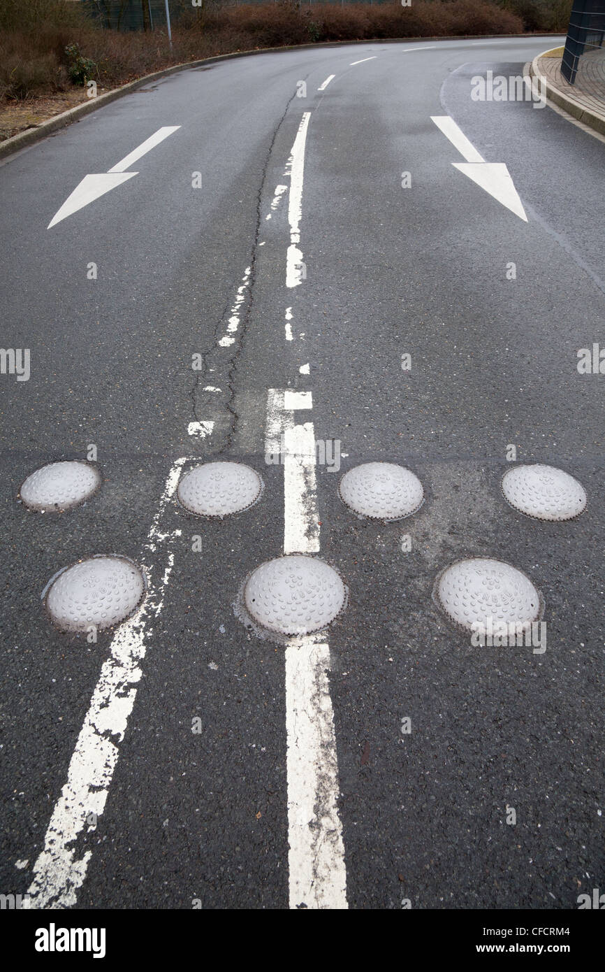 Road with speed bumps and directional arrows Stock Photo - Alamy