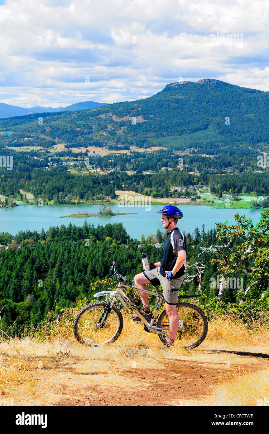 Man taking break enjoying views mountain biking Stock Photo - Alamy