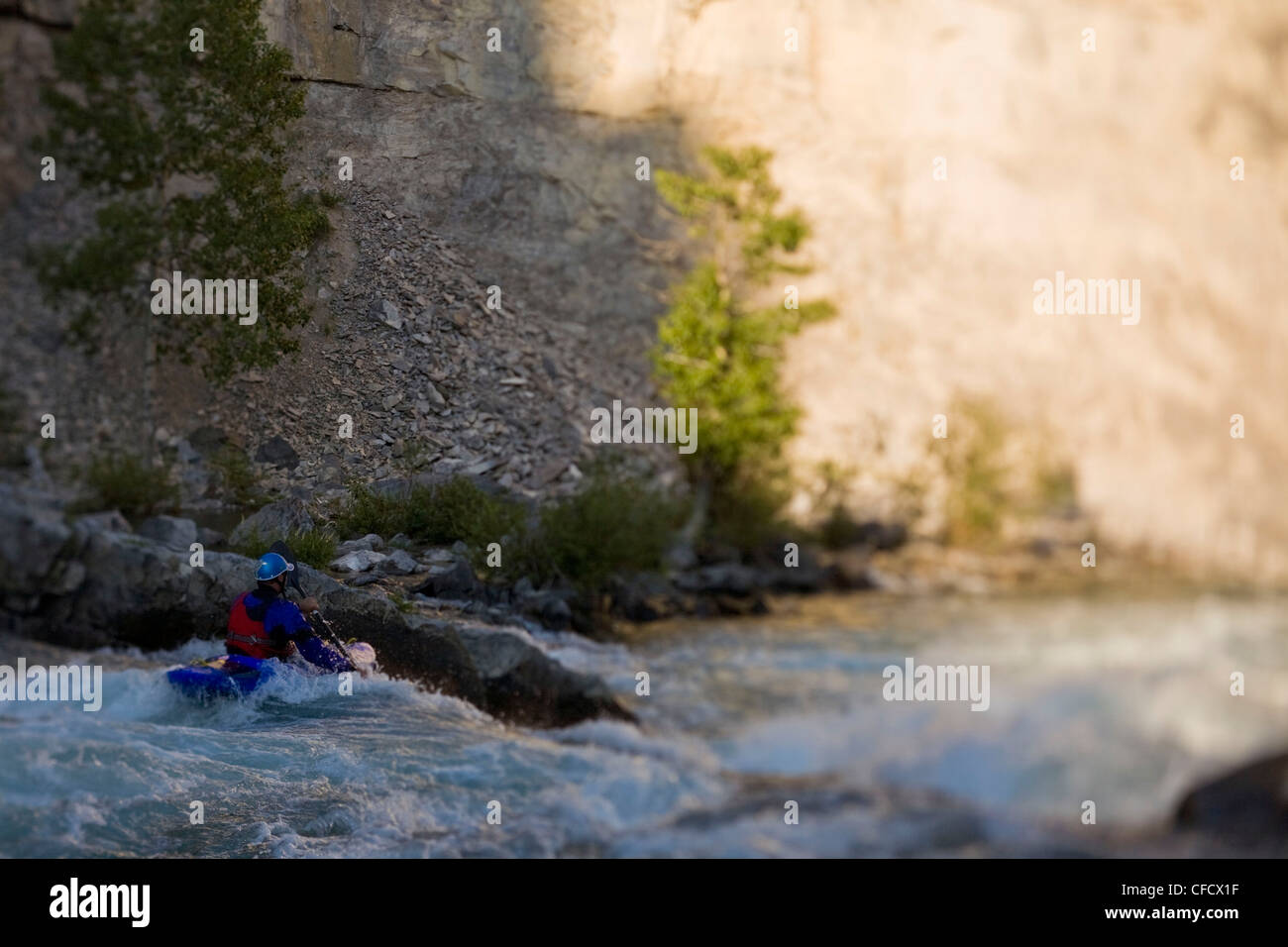 A male whitewater kayaker creekboating on the Elbow River, Alberta ...