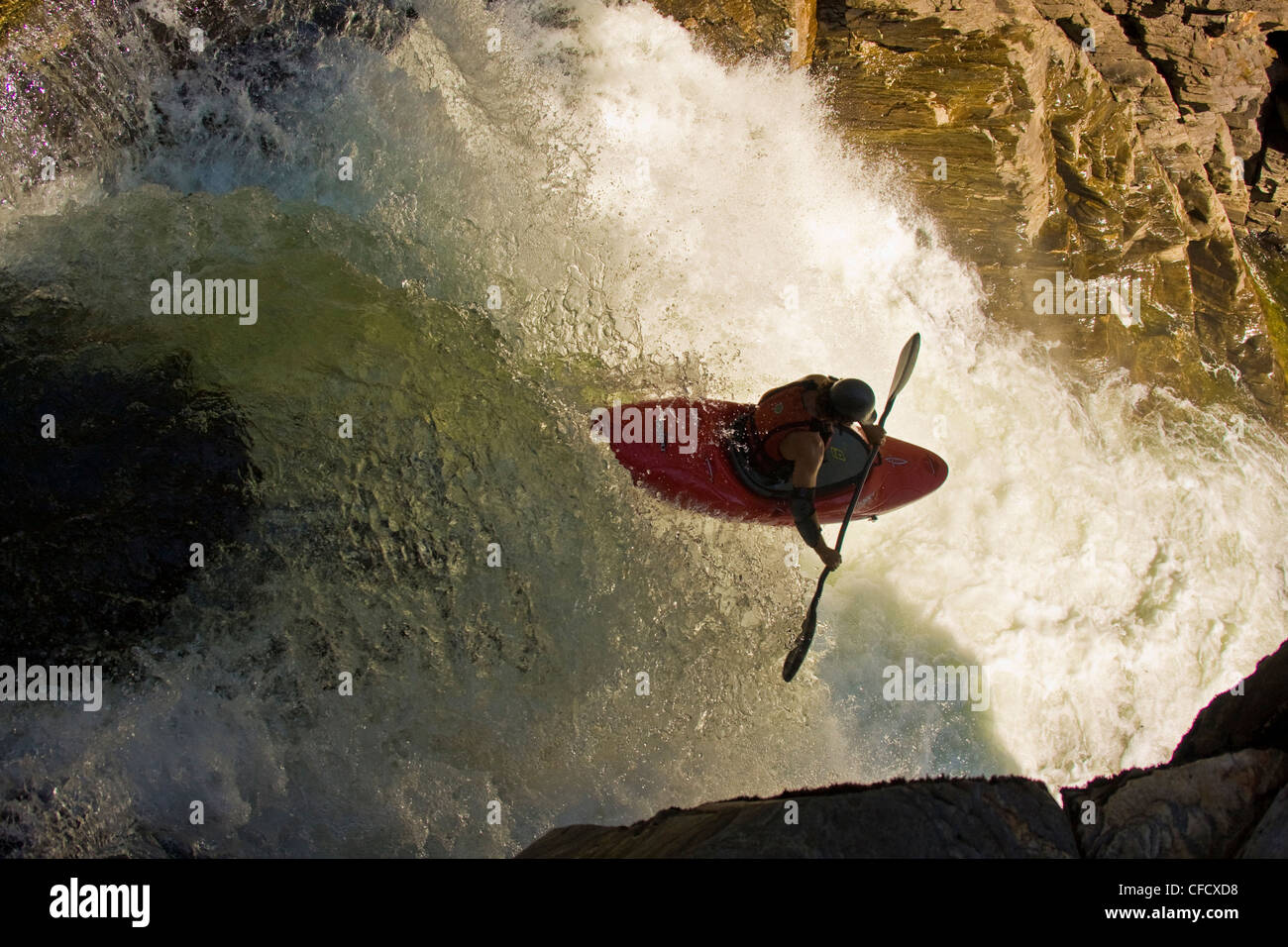 A male kayaker paddles off Raft Falls, Clearwater, British Columbia ...