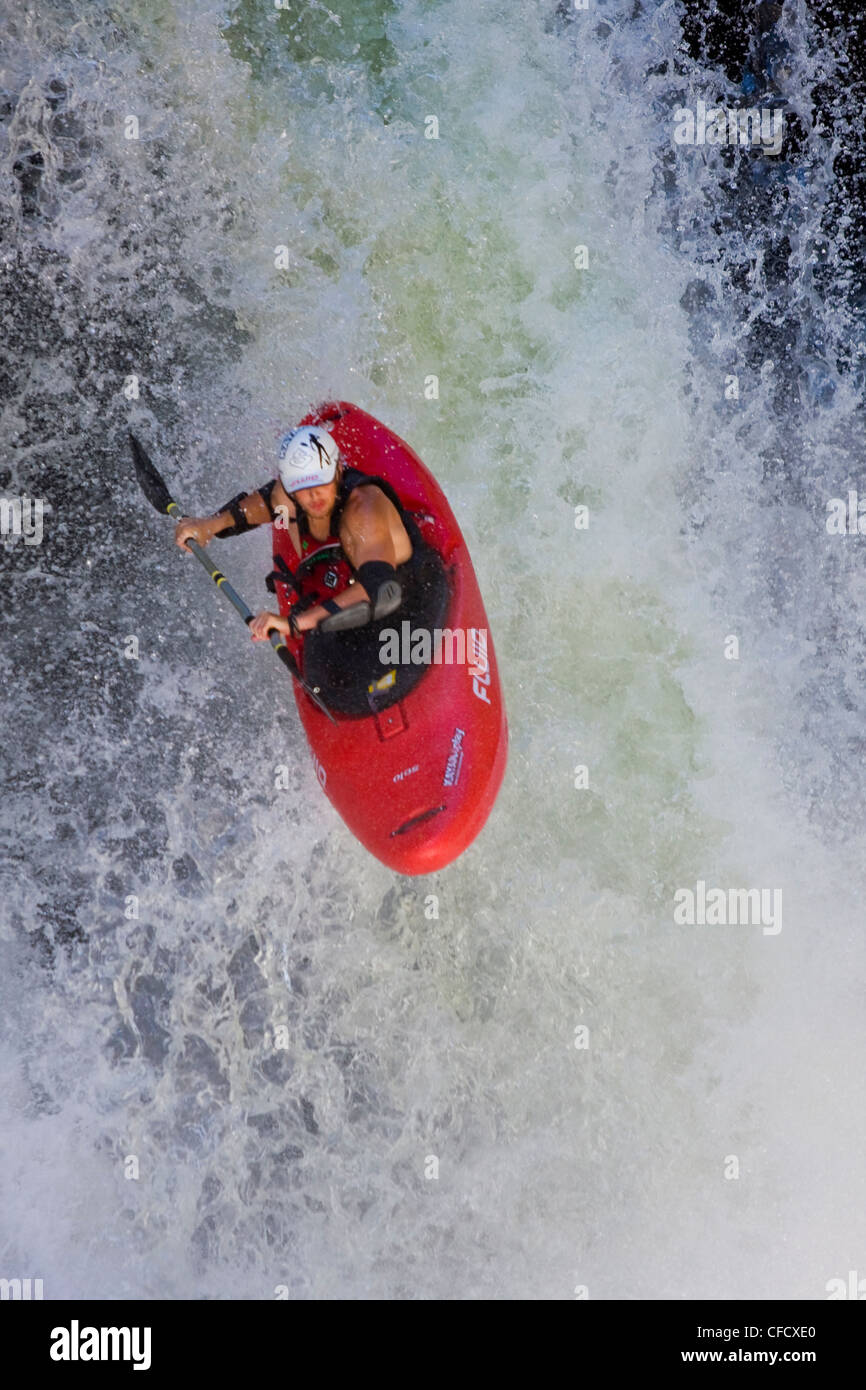 A male kayaker paddles off Raft Falls, Clearwater, British Columbia ...