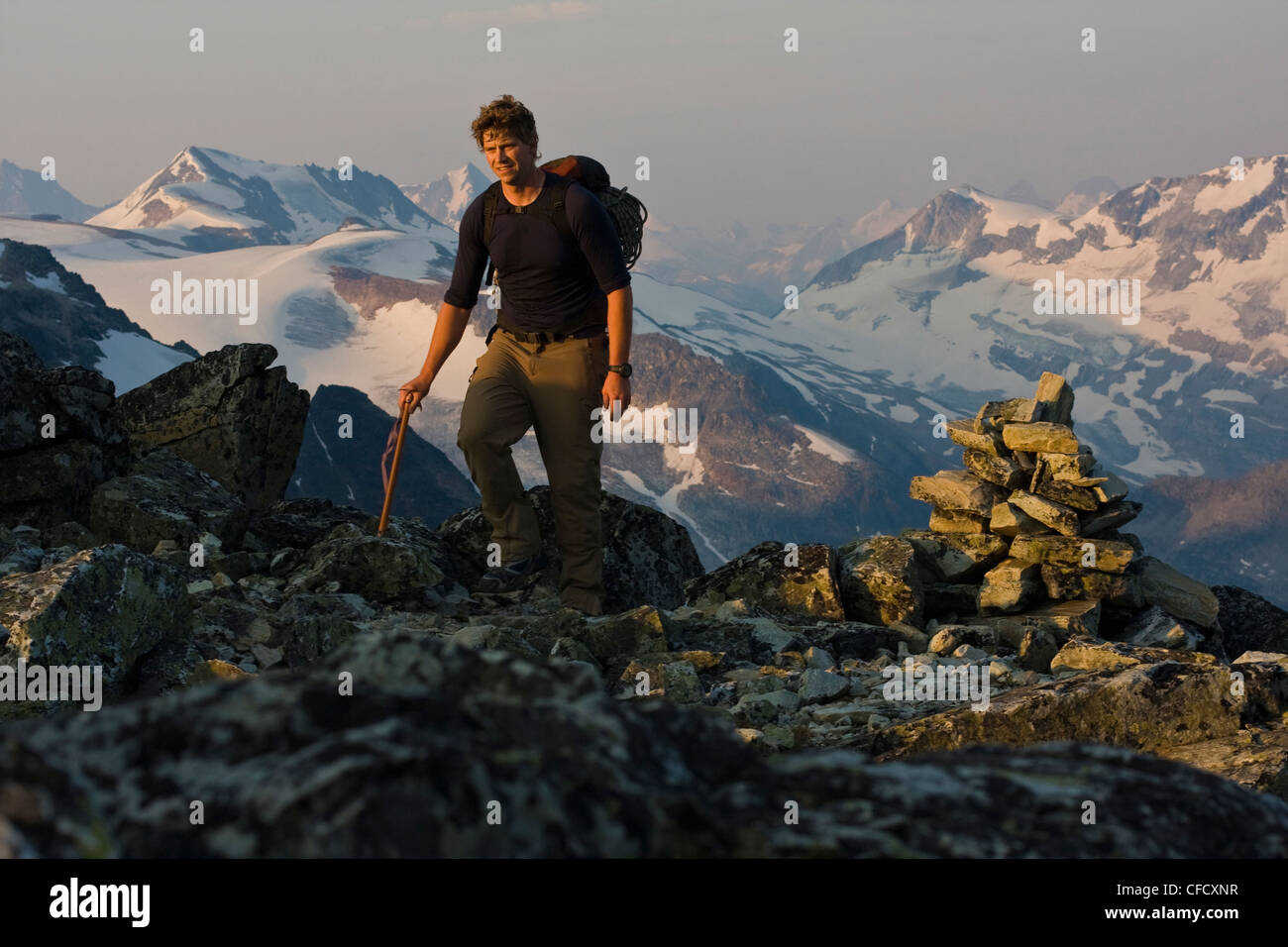 A male climber on the approach to climb Mt. Sir Donald, Glacier ...