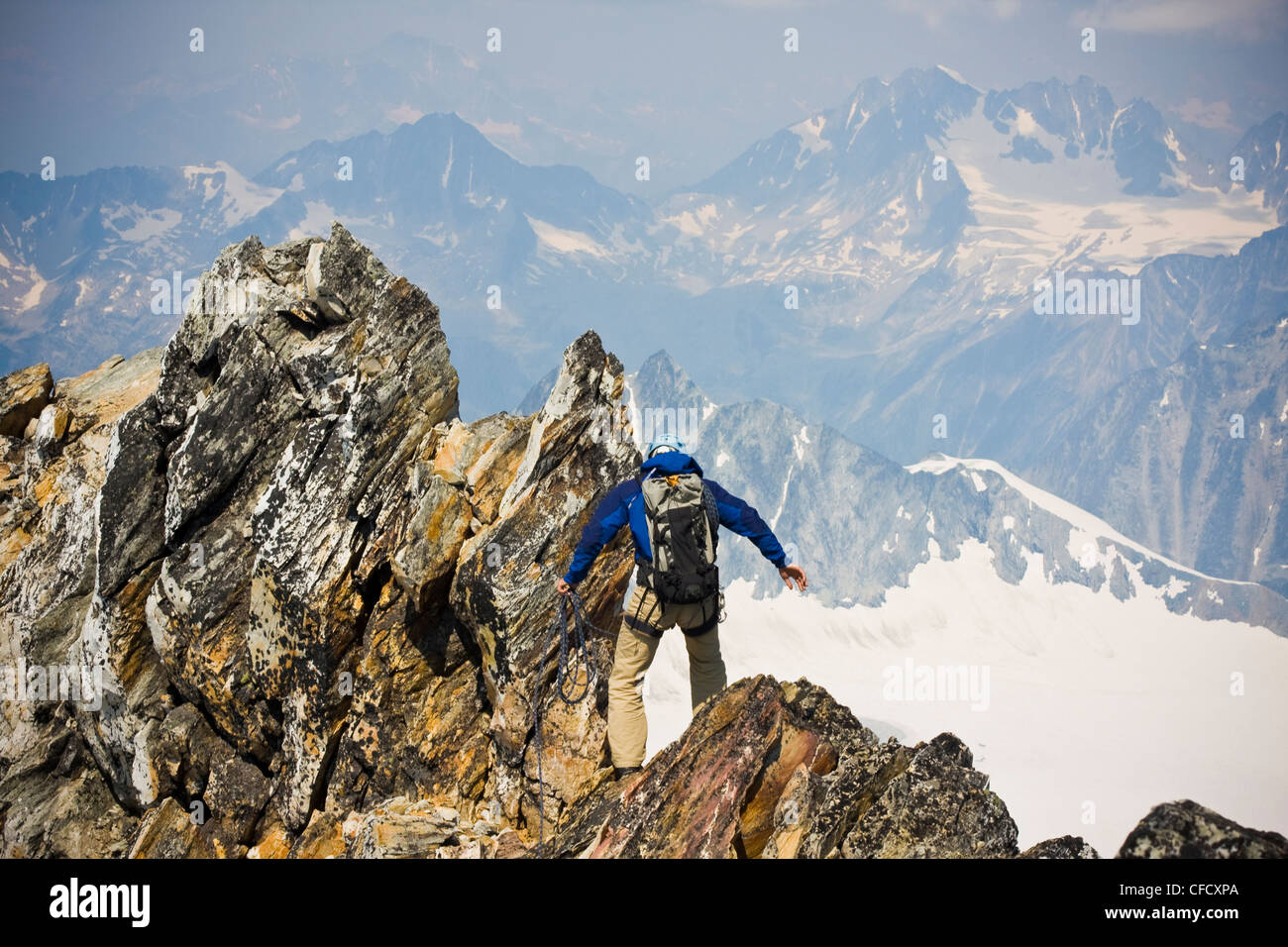 A young man mountain climbing the classic north west ridge of Mt. Sir ...
