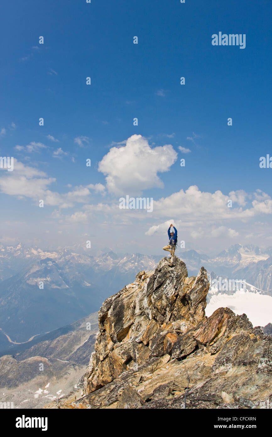 Young man mountain climbing the classic north west ridge of Mt. Sir ...