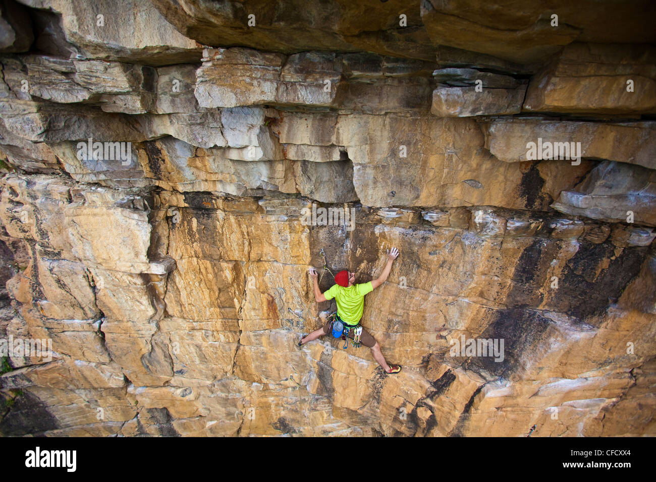 A young man rockclimbing through a tough roof at Lost Boys crag in ...