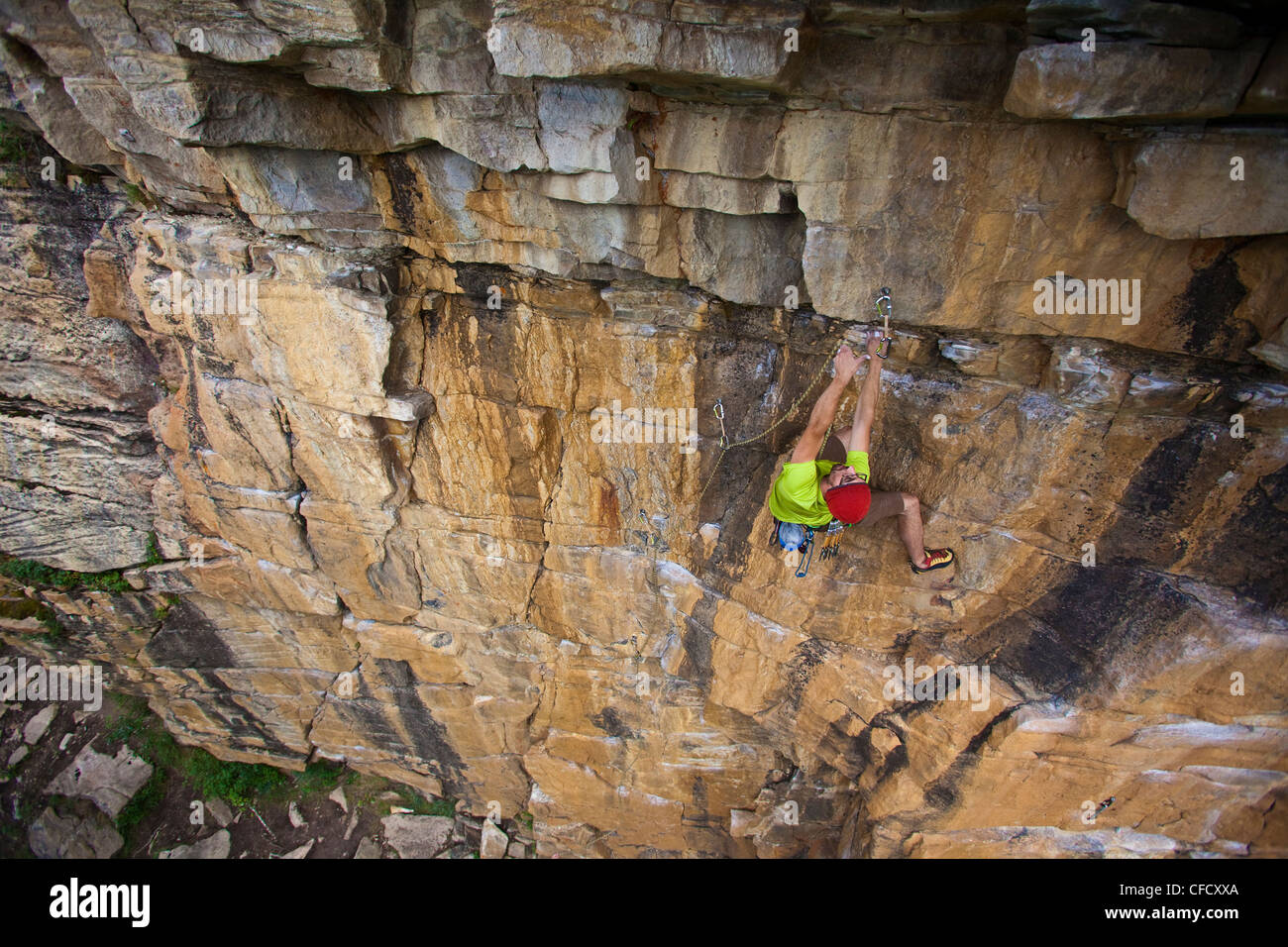 A young man rockclimbing through a tough roof at Lost Boys crag in ...