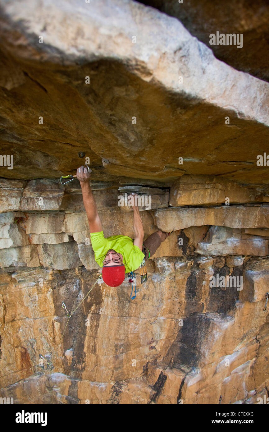 A young man rockclimbing through a tough roof at Lost Boys crag in ...