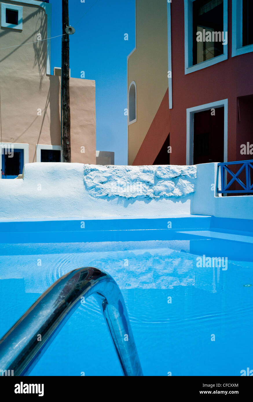 A swimming pool with a ripple in it in a colorful hotel building Stock ...