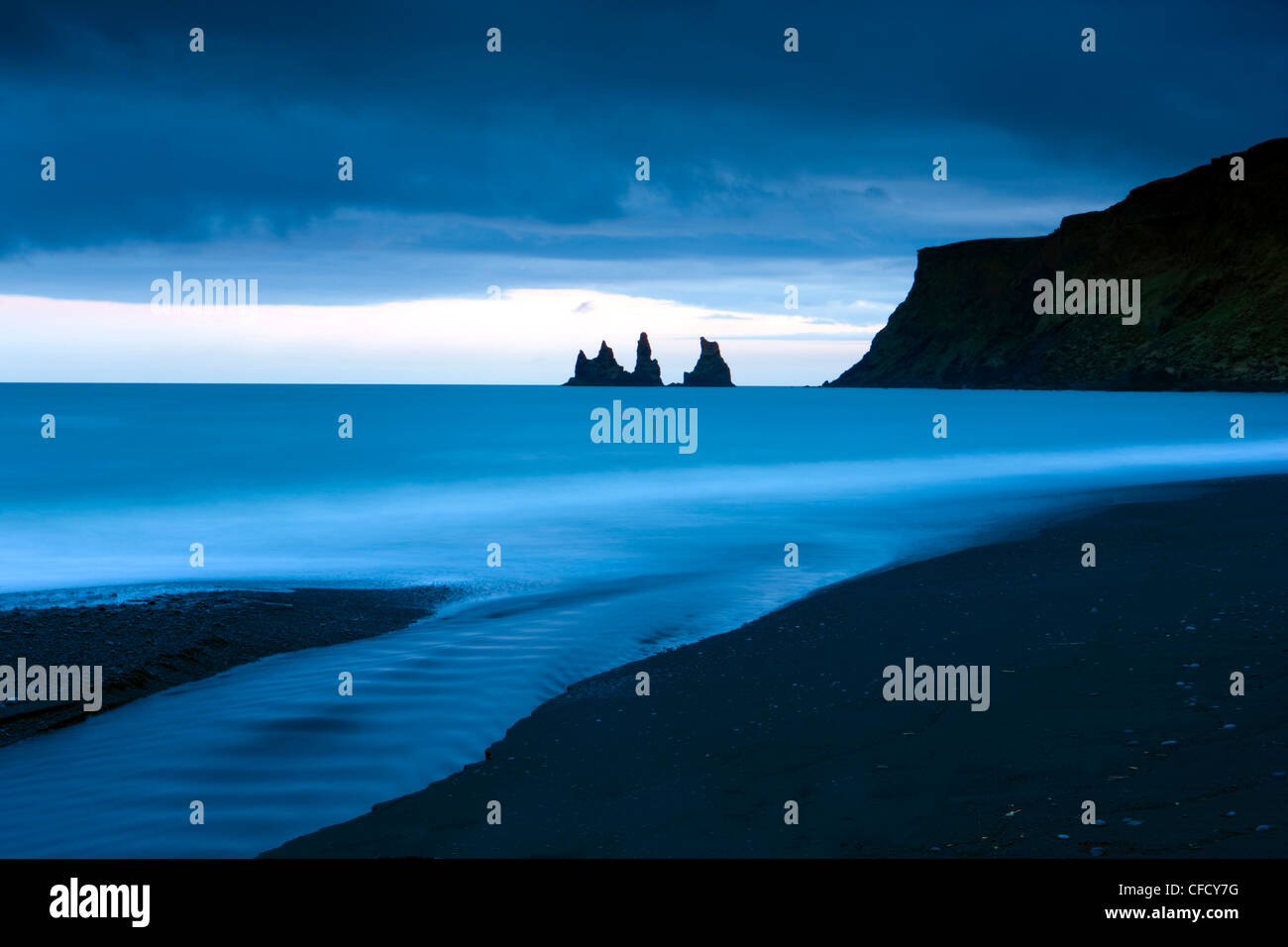 Twilight view towards rock stacks at Reynisdrangar off the coast at Vik ...