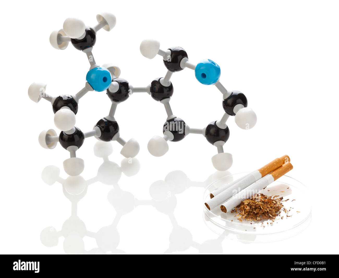 Model of a nicotine molecule with tobacco and cigarettes over white ...