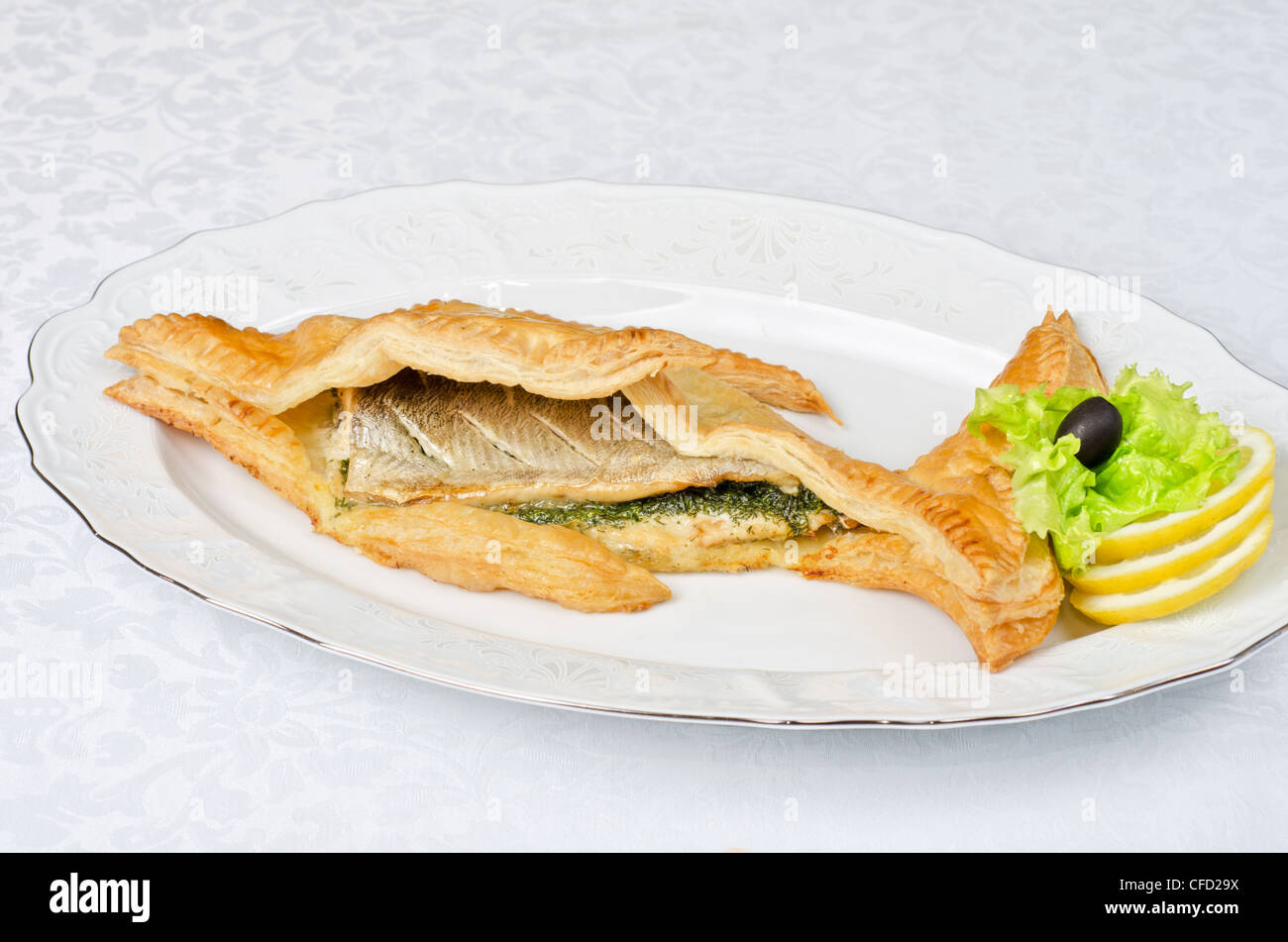 tasty dish of trout fish baked with greens at dough Stock Photo - Alamy