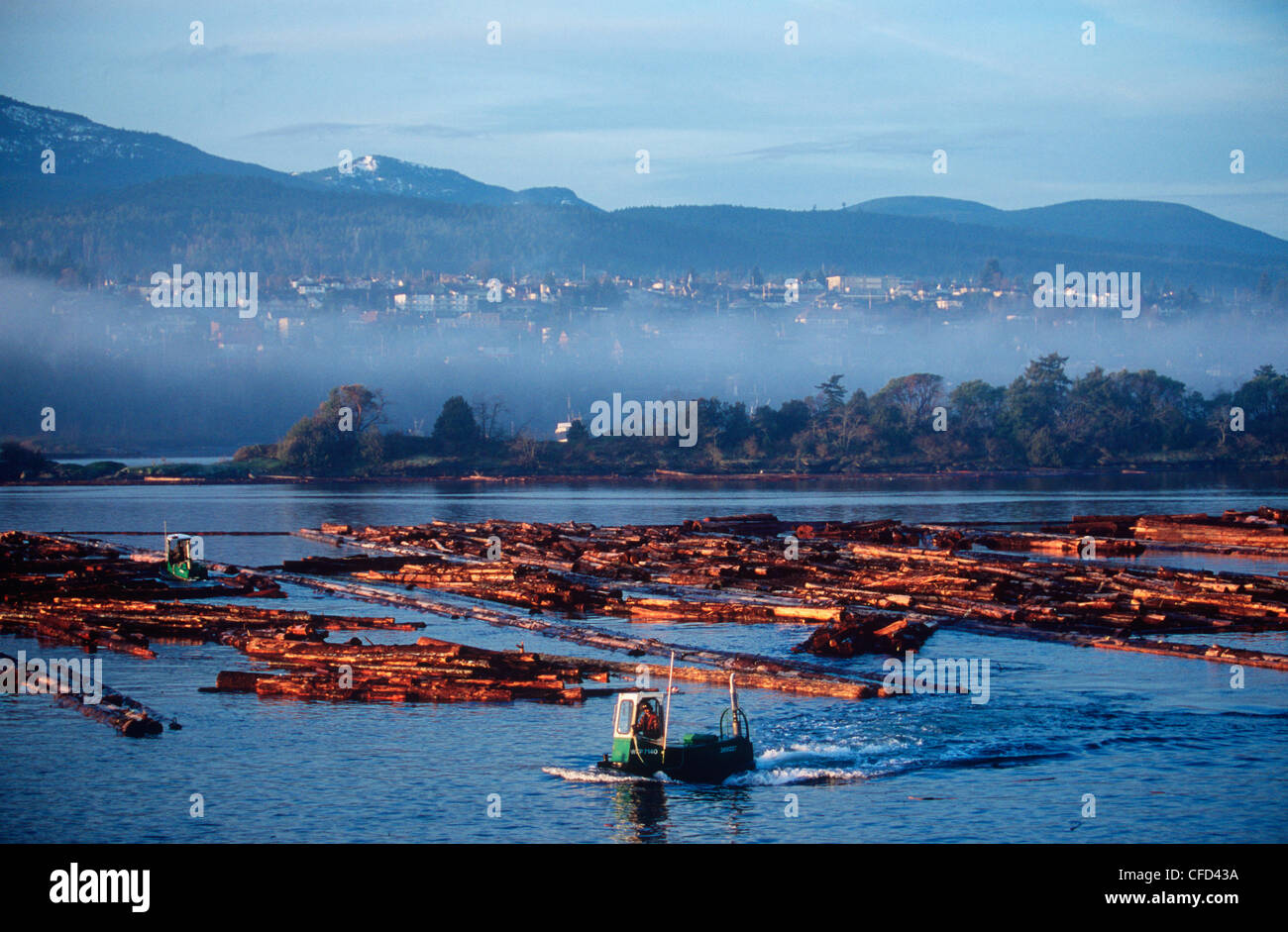 Logging booms in sea- booming boats moving, Ladysmith, British Columbia ...
