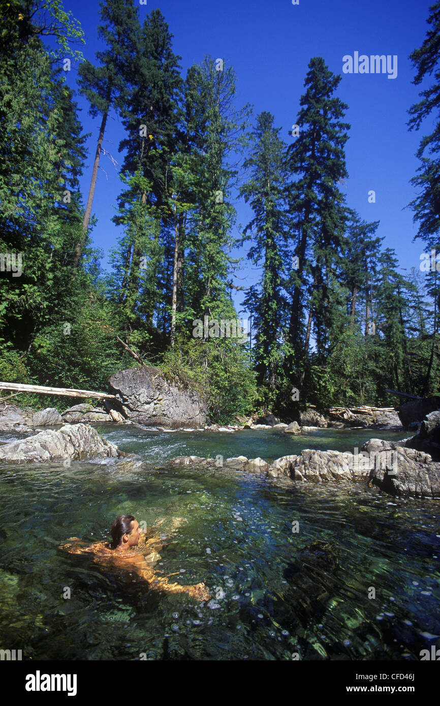 Man swimming in Little Qualicum River, Vancouver Island, British ...