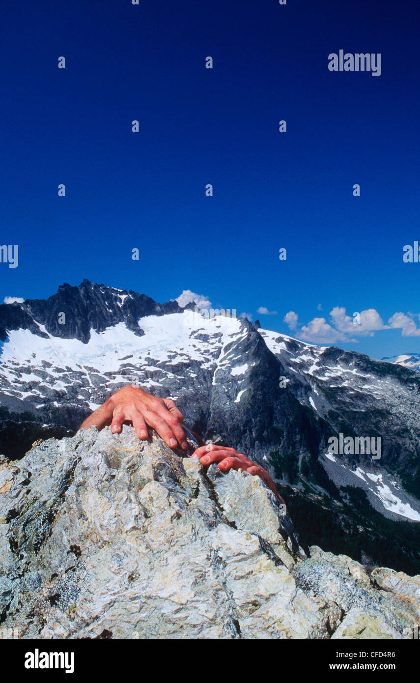 climber hands atop rock peak in Tantalus Range, Whistler, British ...