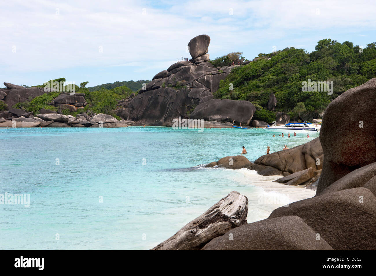 Tourists standing on top of Sail Rock and on sandy beach at Sail Rock ...