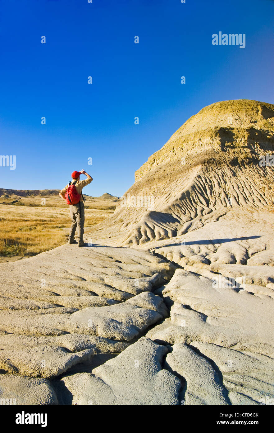 Hiker in the Killdeer Badlands, East Block, Grasslands National Park ...