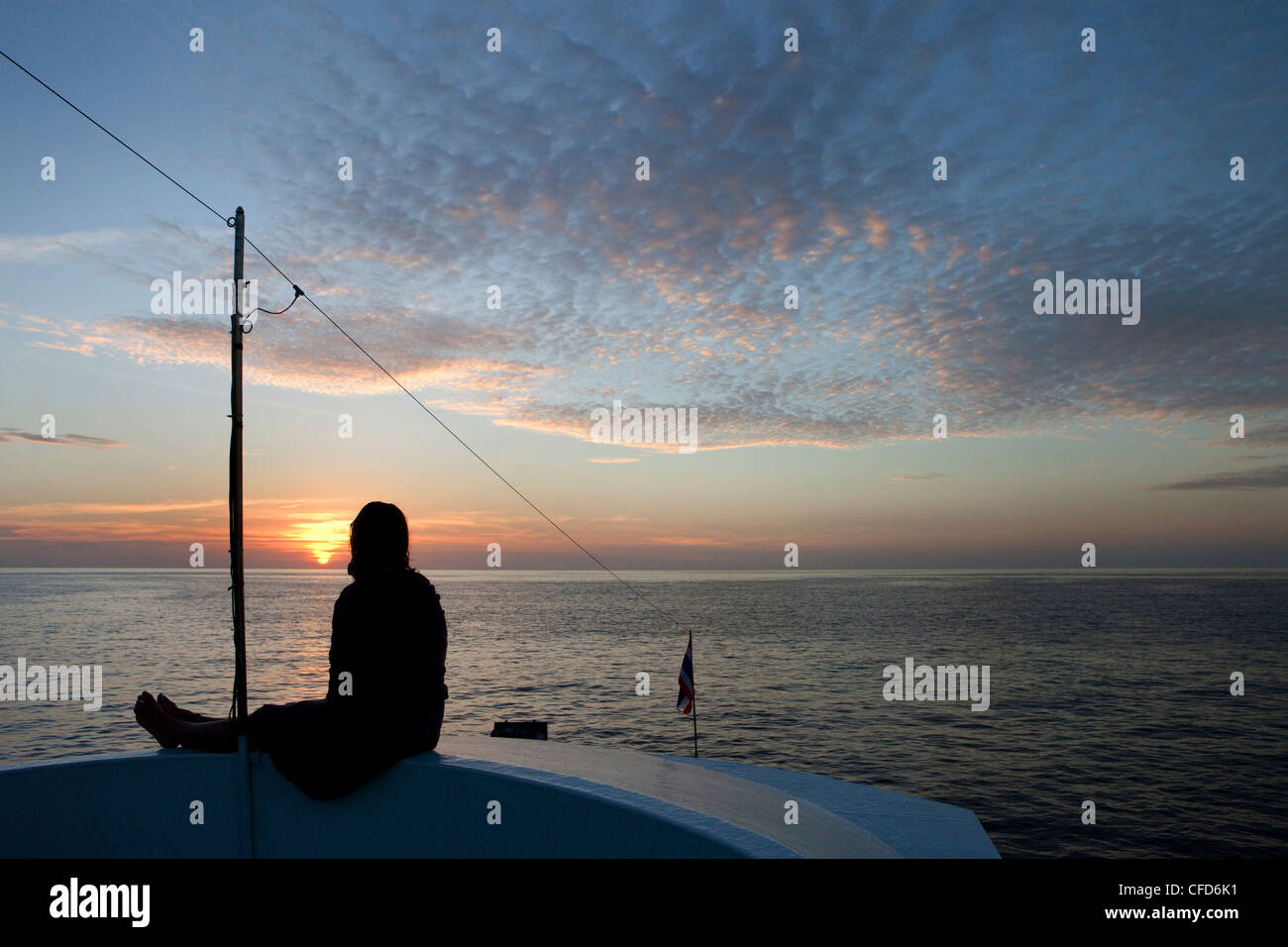 Woman diving tourits enjoying sunset on the diving boat, Similan ...