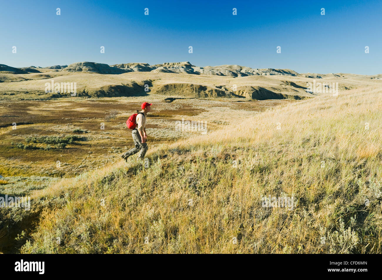 Hiker in the Killdeer Badlands, East Block, Grasslands National Park ...