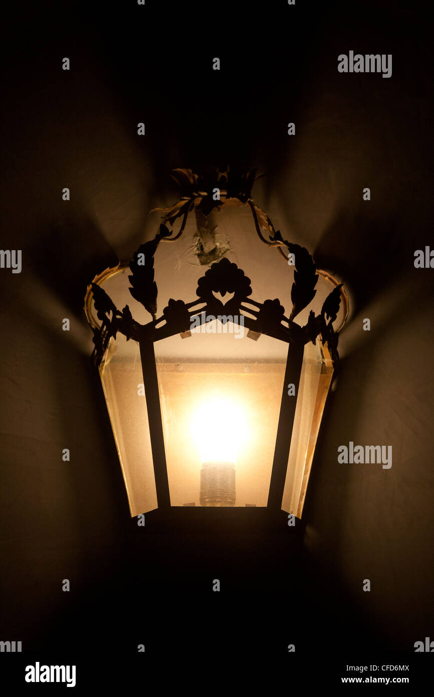 A Venetian lantern casting a shadow on a wall in a corridor, Venice ...