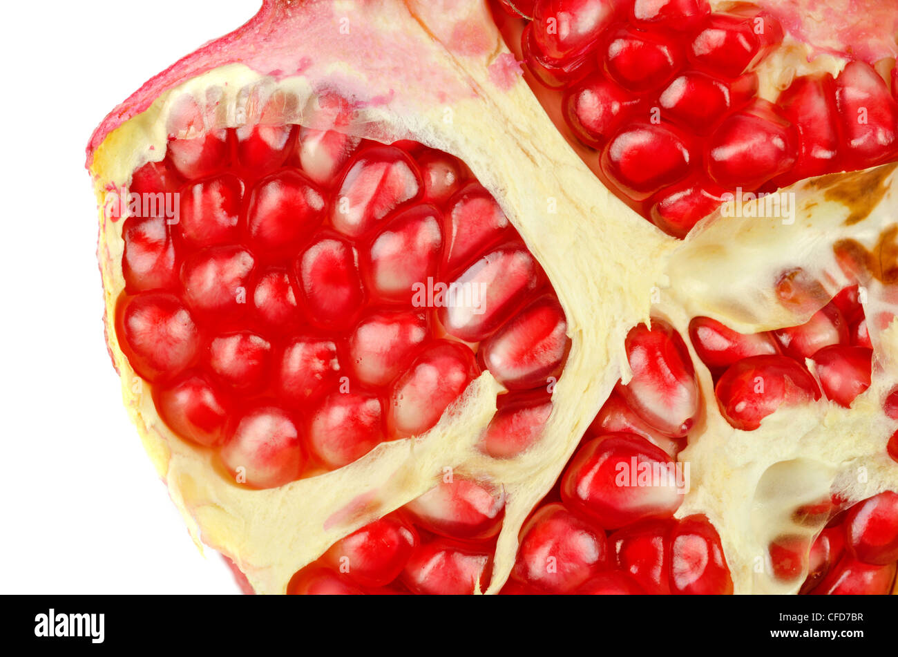 Half of pomegranate closeup on a white background Stock Photo - Alamy