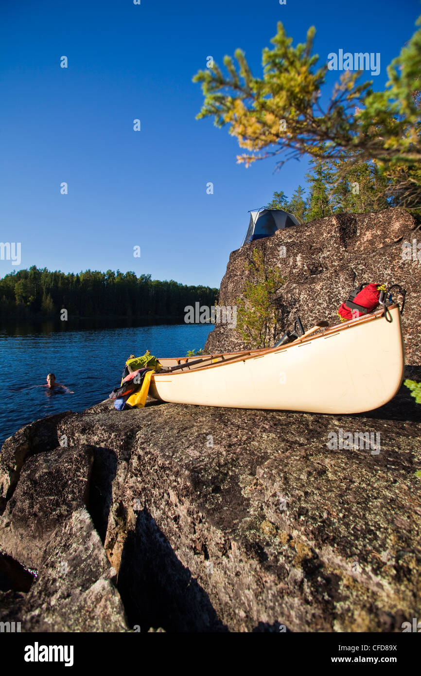 A young man canoeing and camping for 2 weeks in Wabakimi Provincial ...