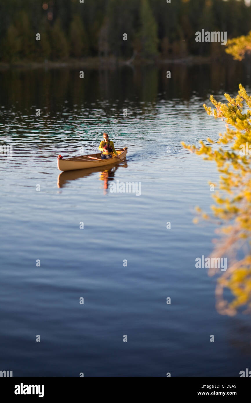 A young man canoeing and camping for 2 weeks in Wabakimi Provincial ...