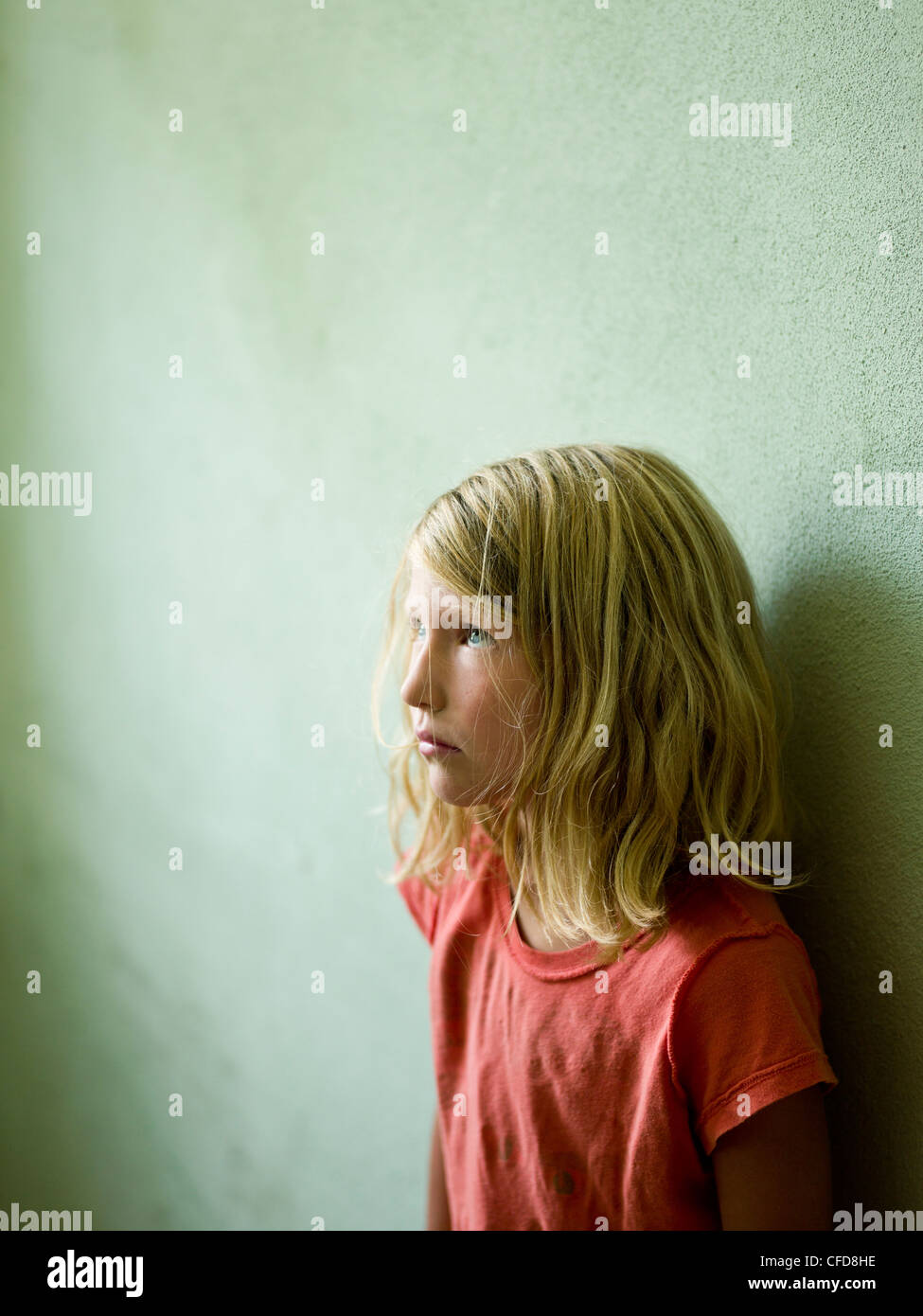 a girl poses leans against the wall looking up to the ceiling Stock ...