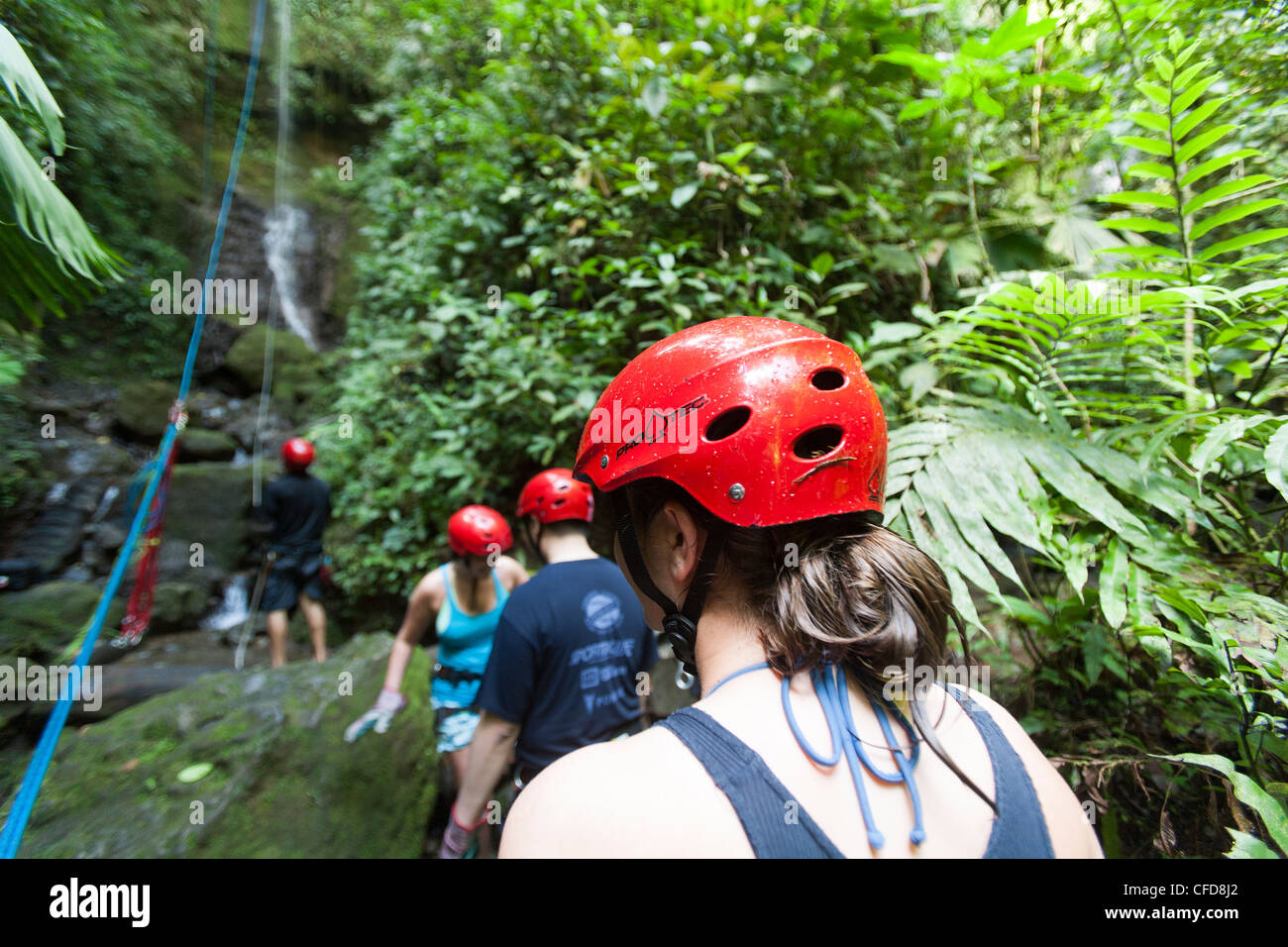 Tourists and guides with rope canyoneering and rappelling around the ...