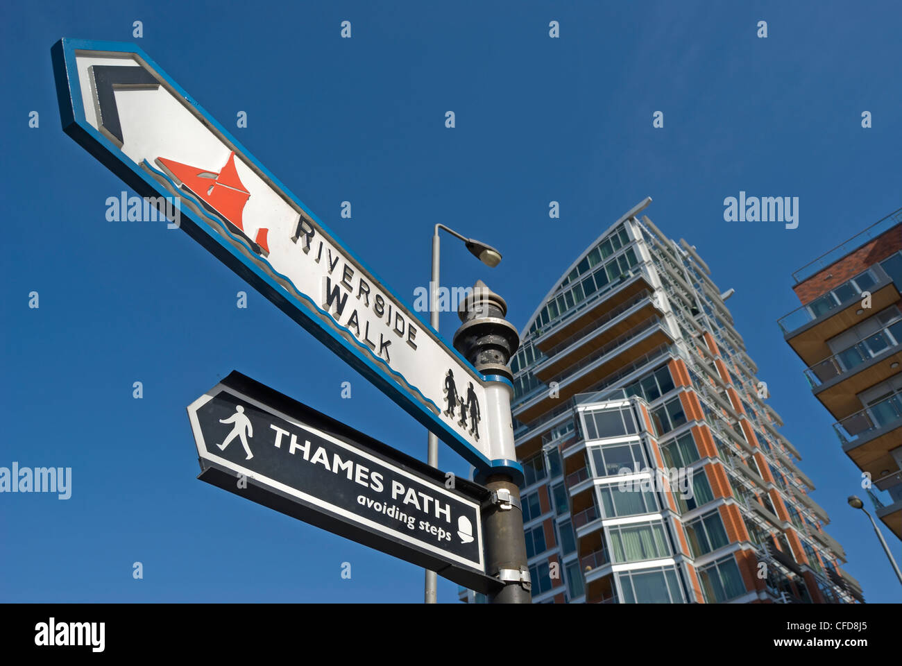 signs for riverside walk and thames path, with modern high rise ...