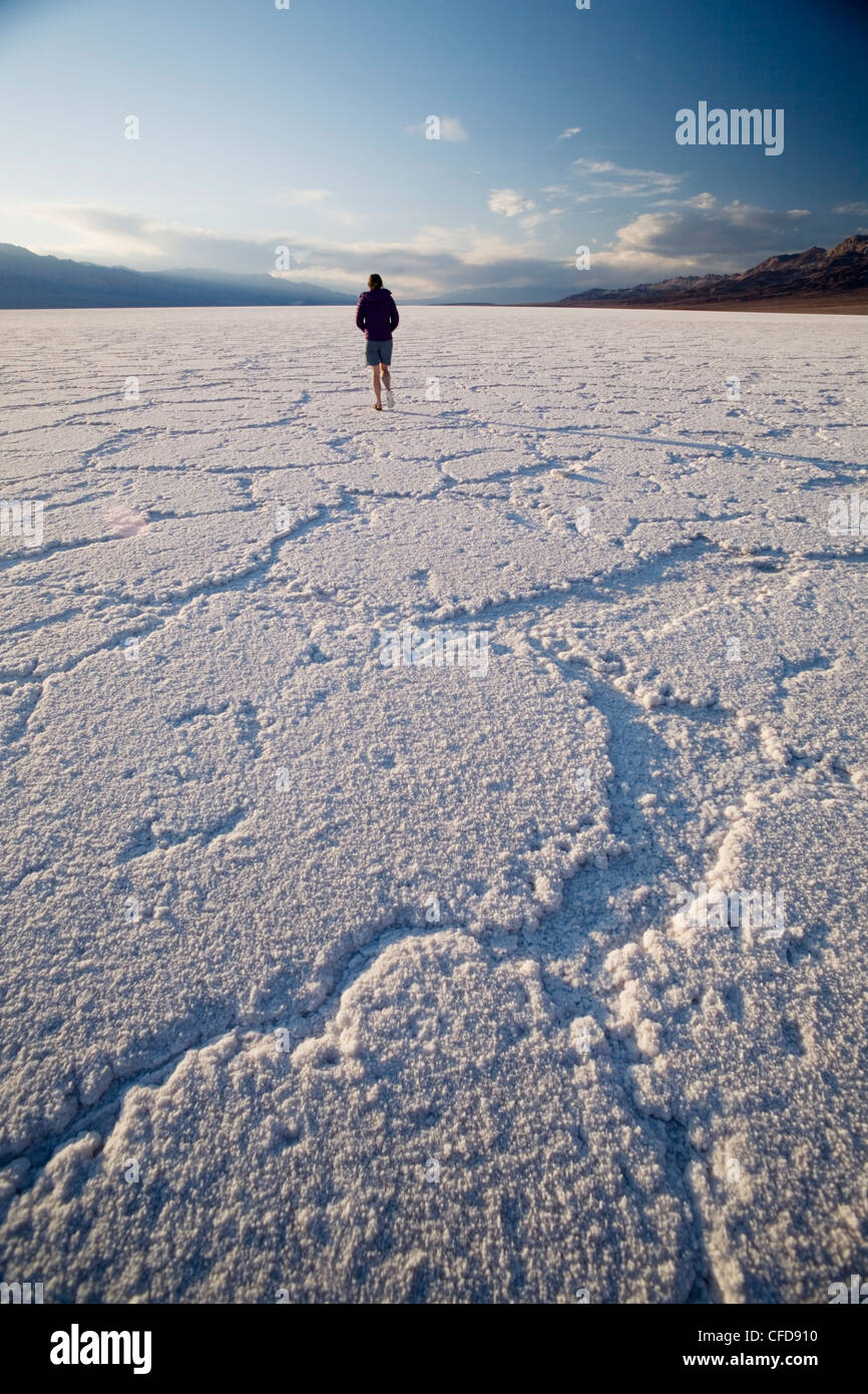 Woman walking on salt flats, Badwater Basin, Death Valley National Park ...