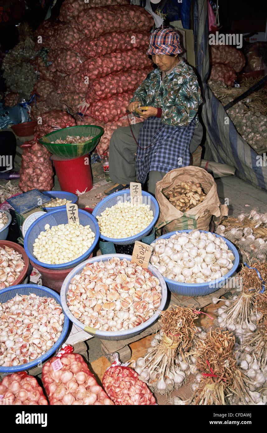 Korea, Seoul, Namdaemun Market, Woman Peeling Garlic in Outdoor Garlic ...