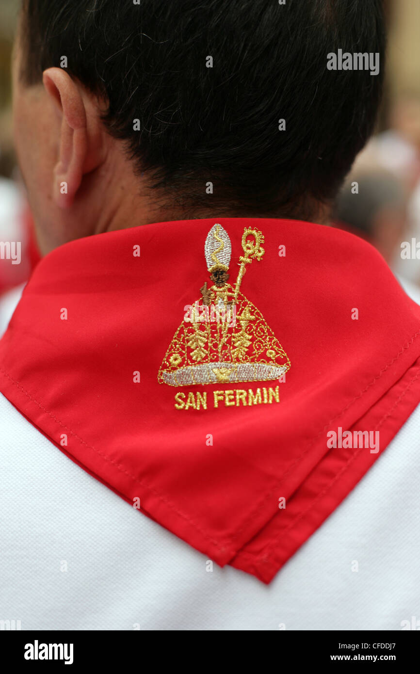 Young man wearing San Fermin neckscarf at the running of the bulls in Pamplona, Navarra, Spain ...