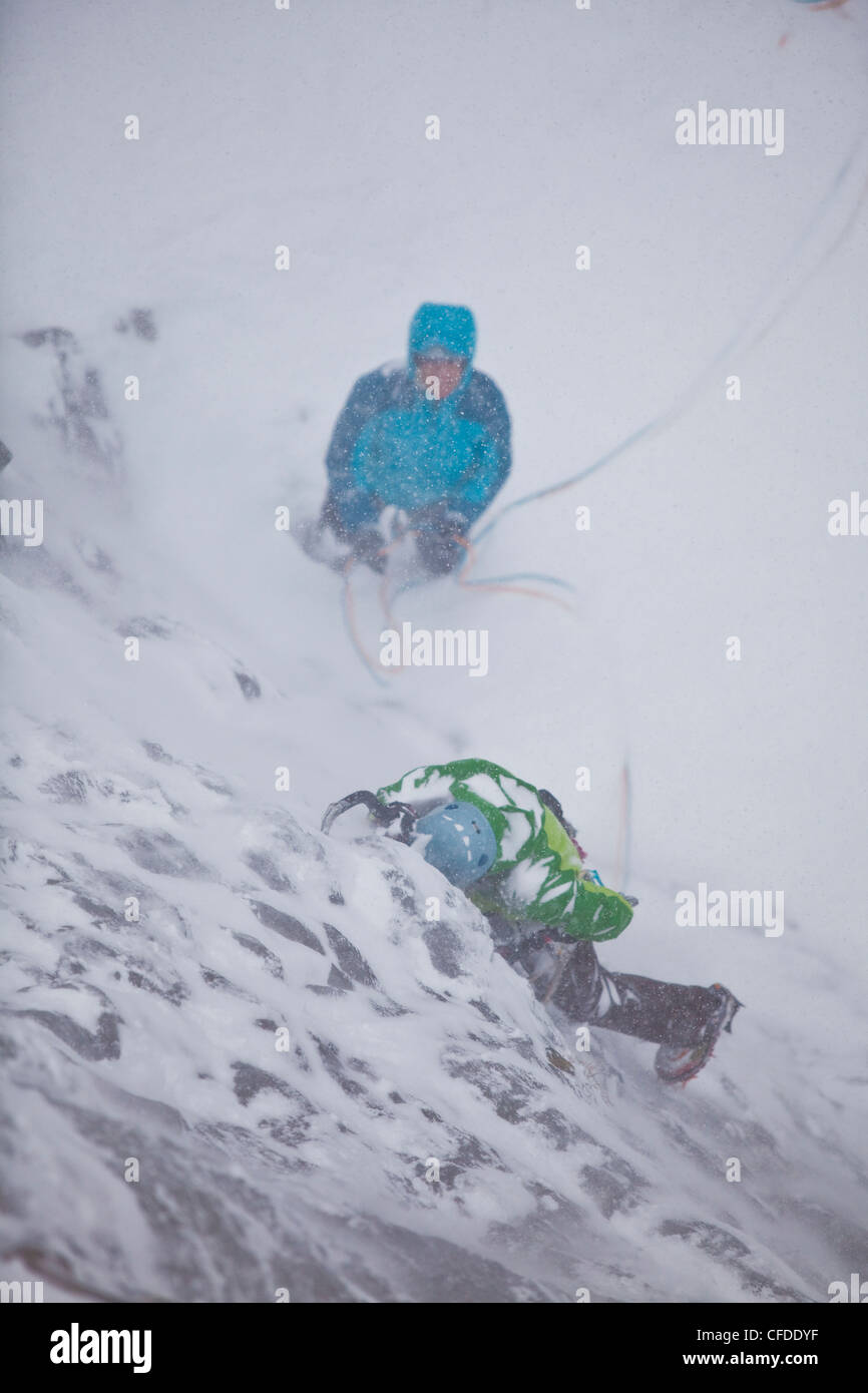 A strong female ice climber works her way up Snowline WI4, Even Thomas ...