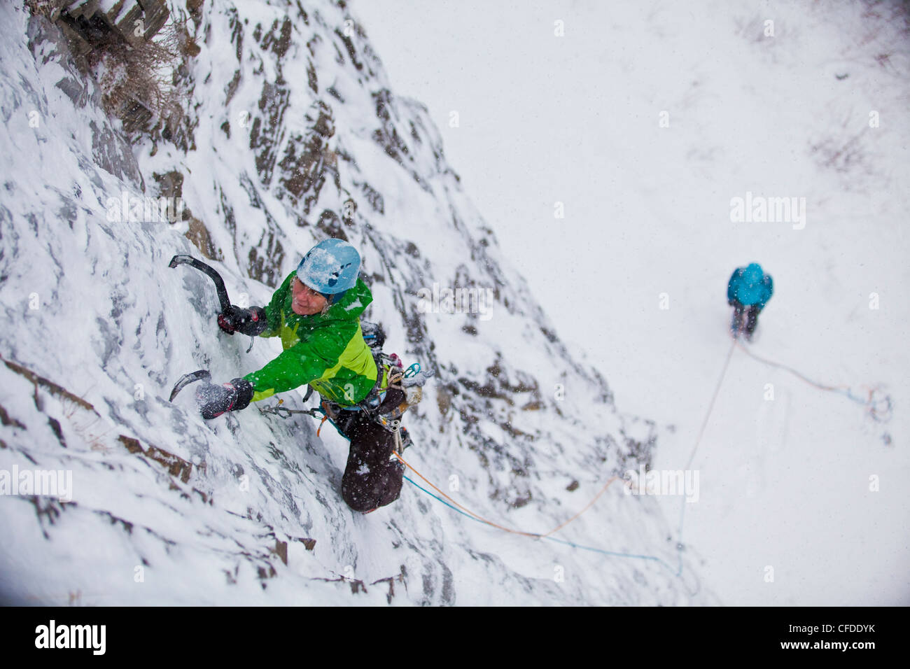 A strong female ice climber works her way up Snowline WI4, Even Thomas ...