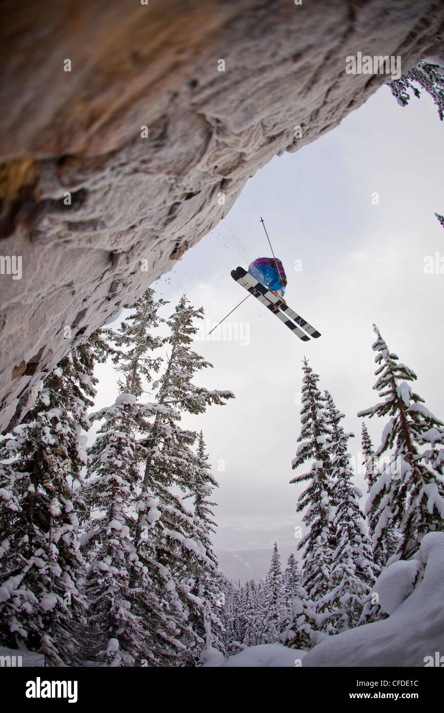 A young male skier drops a big cliff at Kicking Horse Resort, Golden ...