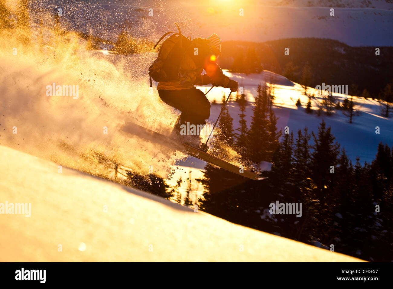 backcountry skier spraying powder alpenglow Stock Photo - Alamy