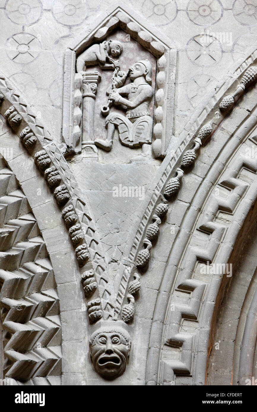 A 12th century corner stone,a man performing with a monkey, Notre Dame ...