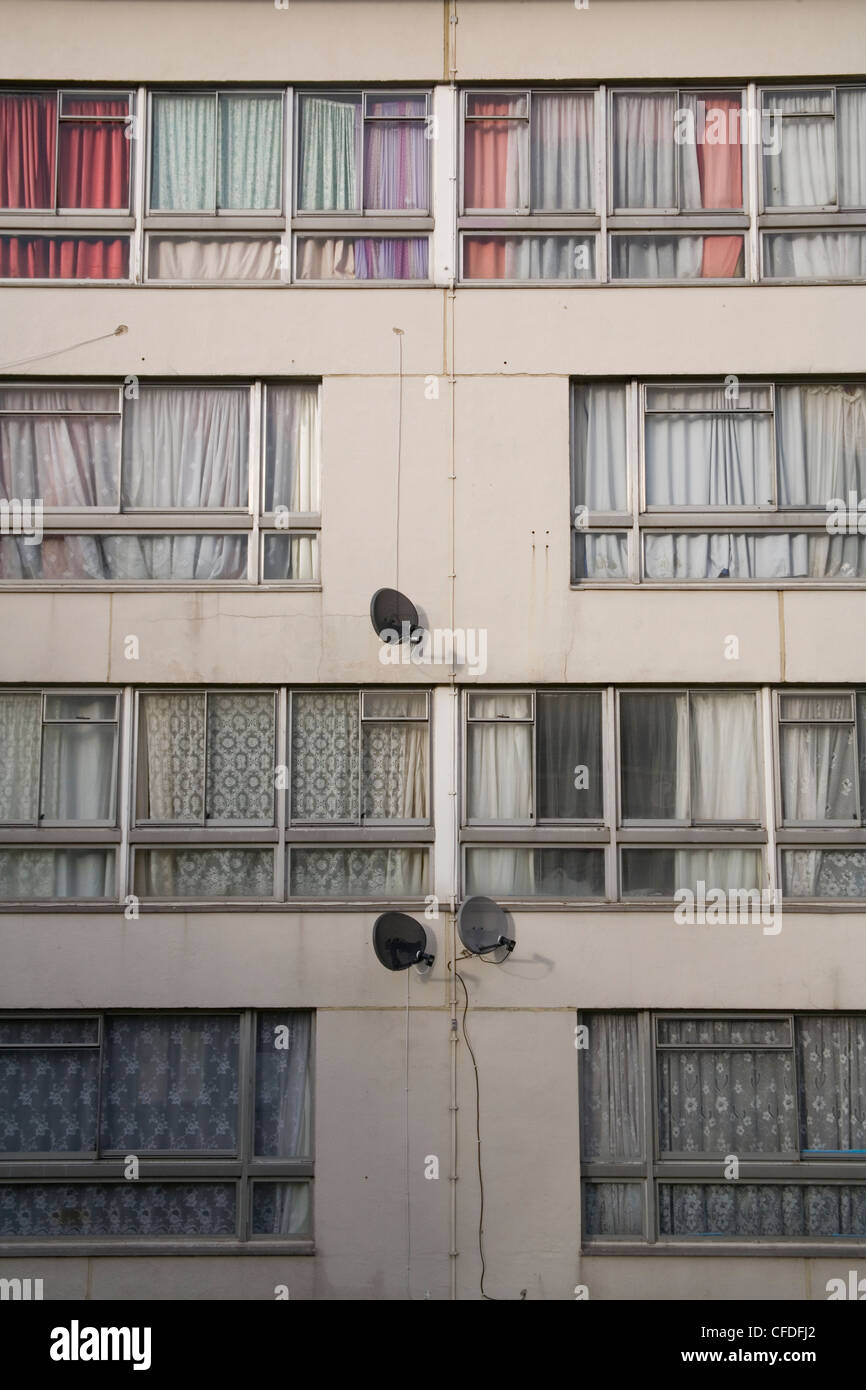 Wall of Windows with curtains on council estate Stock Photo - Alamy