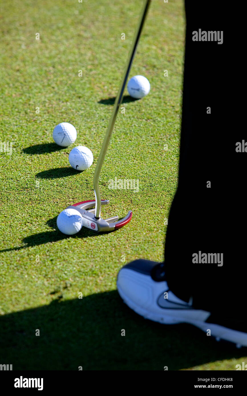 Detail on a golf player playing golf. Feet of golf player, golf club ...