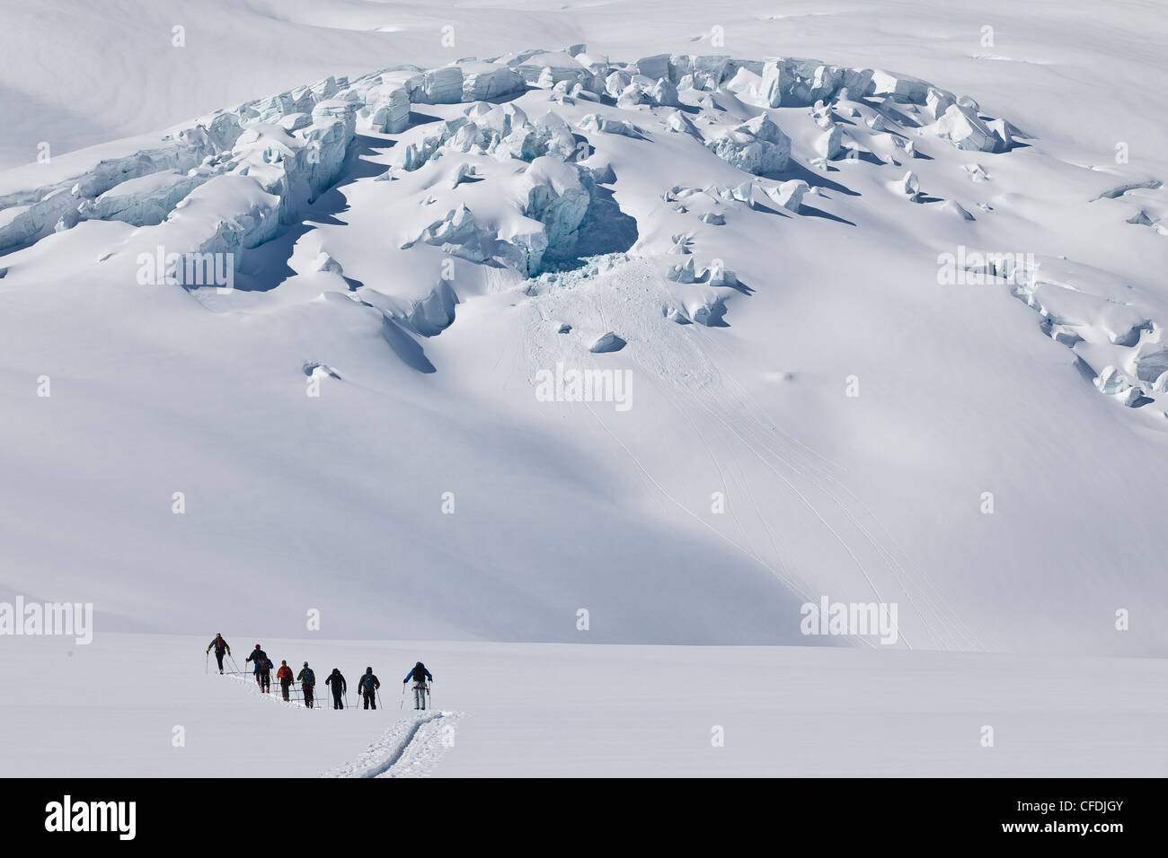 Backcountry skiers ski touring in the Selkirk Range near the Fairy ...
