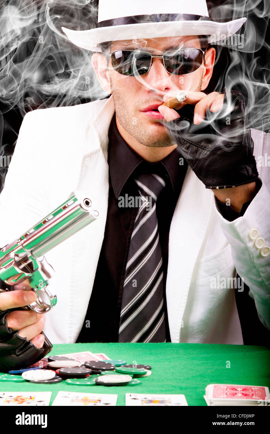 View of a gangster man playing some cards and poker, smoking a Cuban ...