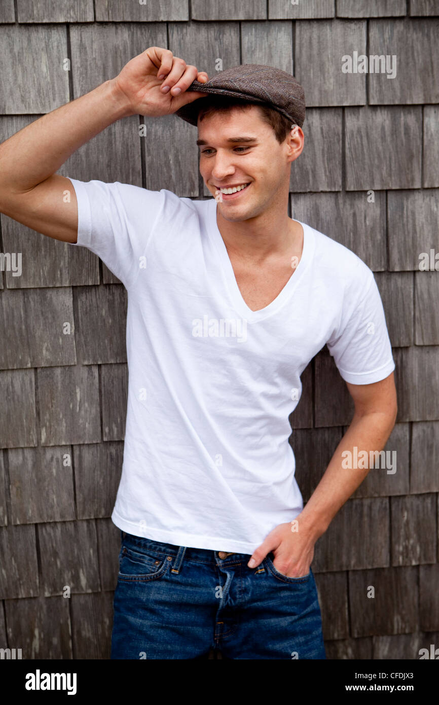 Young manwearing a hat and smiling Stock Photo - Alamy